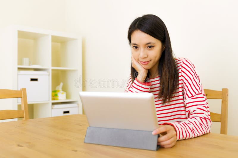 Asian Woman Looking at Computer Tablet Stock Image - Image of sitting ...