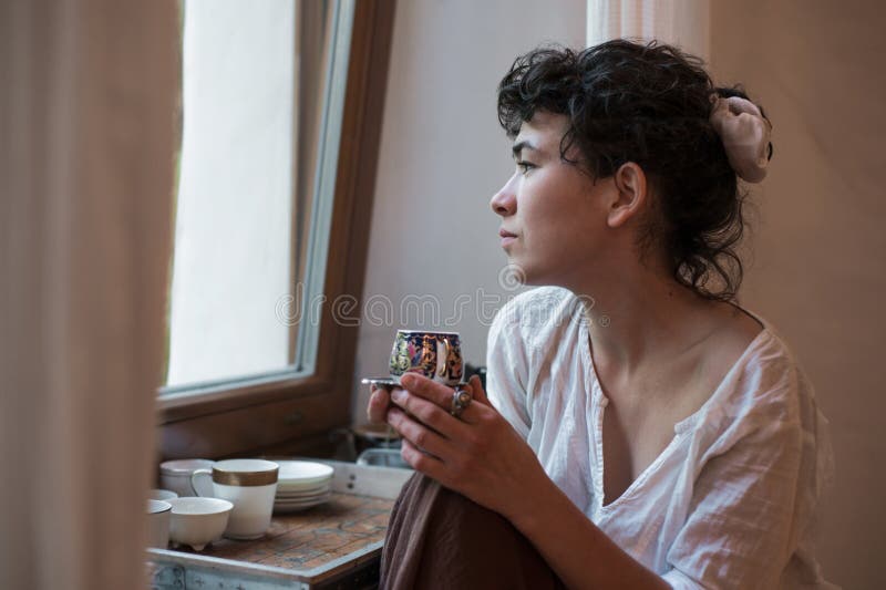 Asian Woman Looking Out the Window and Drinking Tea Stock Image - Image ...