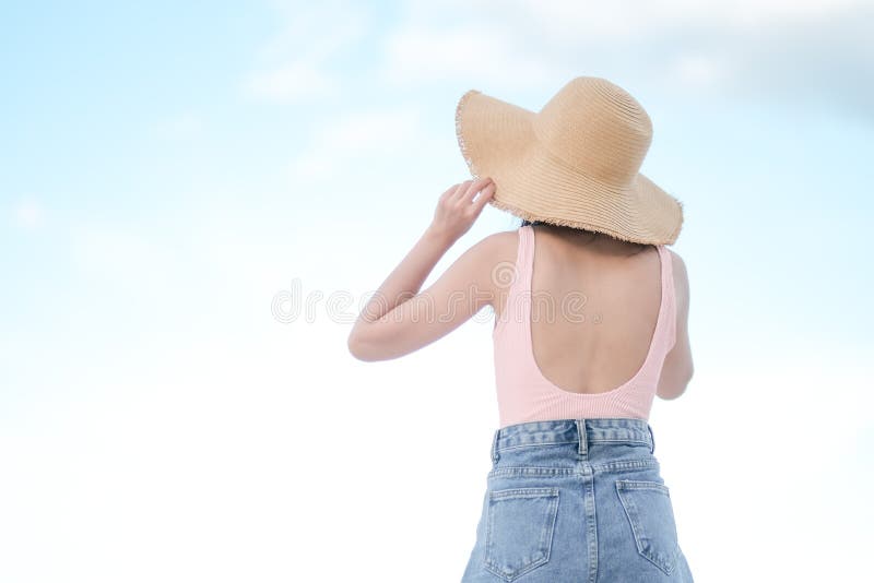Asian Woman With Pink Swimsuit And Straw Hat On The Beach Stock Image
