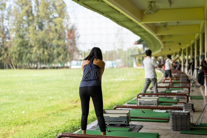 Asian Woman Practicing His Golf Swing at the Golf Driving Range ...