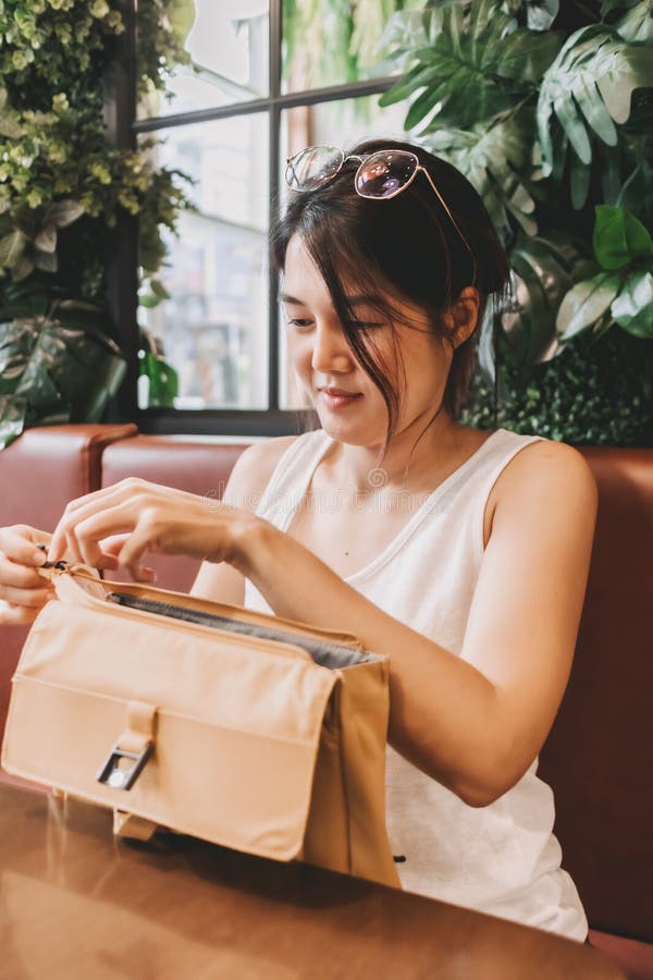 Woman Putting Her Laptop Computer into Her Backpack. Just Finished Her ...