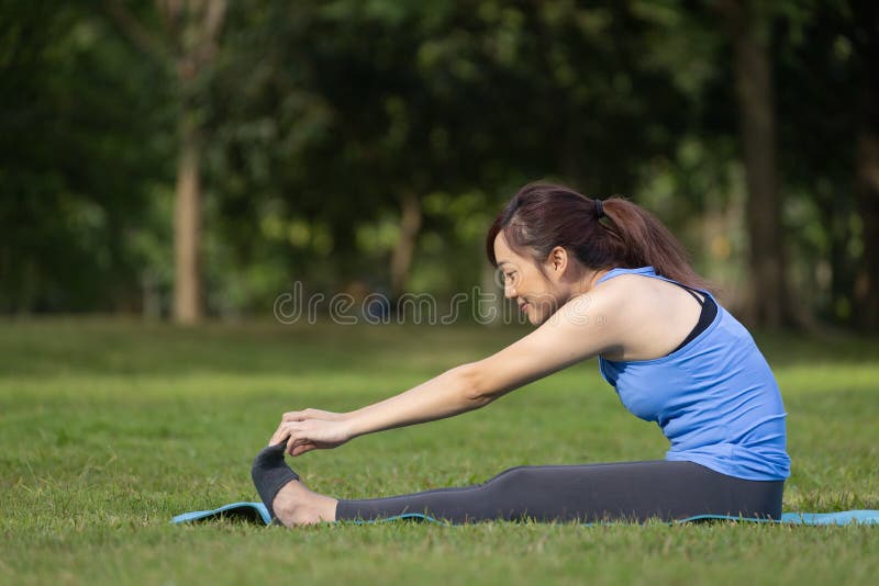 Asian Woman Relaxingly Practicing Forward Bending Yoga or Hamstring ...