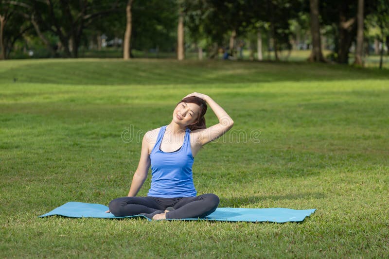 Asian Woman Relaxingly Practicing Neck and Shoulder Stretching Yoga ...