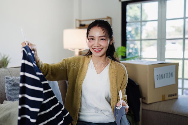 Asian Woman Select Clothes at Home To Put in a Donation Box Second Hand ...