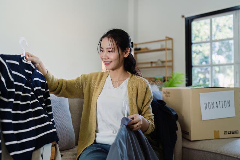 Asian Woman Select Clothes at Home To Put in a Donation Box Second Hand ...