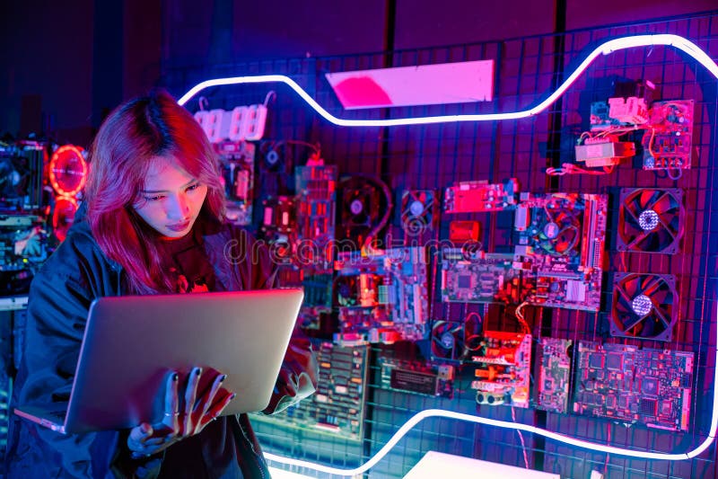 Asian Woman is Sitting at a Desk with a Laptop Service in Server Room ...