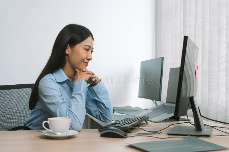 Asian Woman Software Developers Sitting in Front of Computers Looking ...
