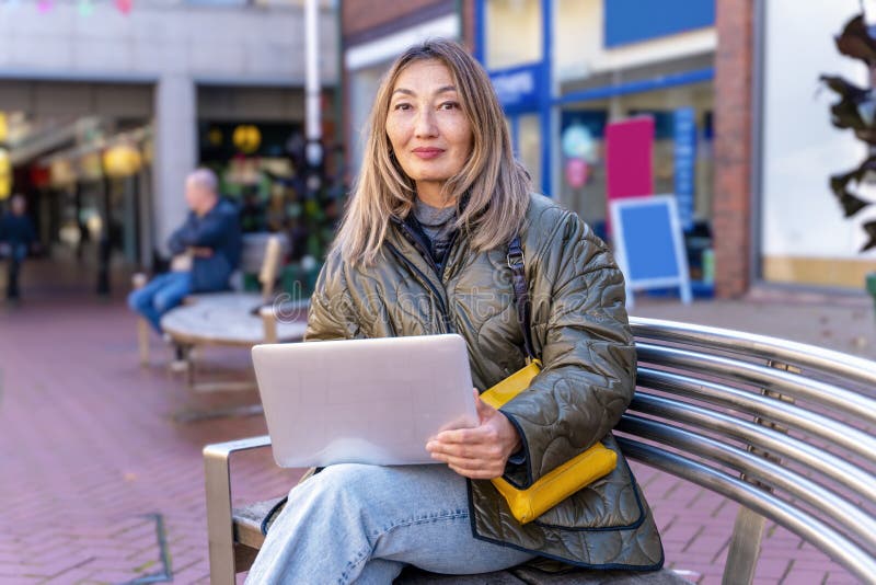 Asian Woman Student Writing in Notebook in a Cafe. Concept of Study at ...