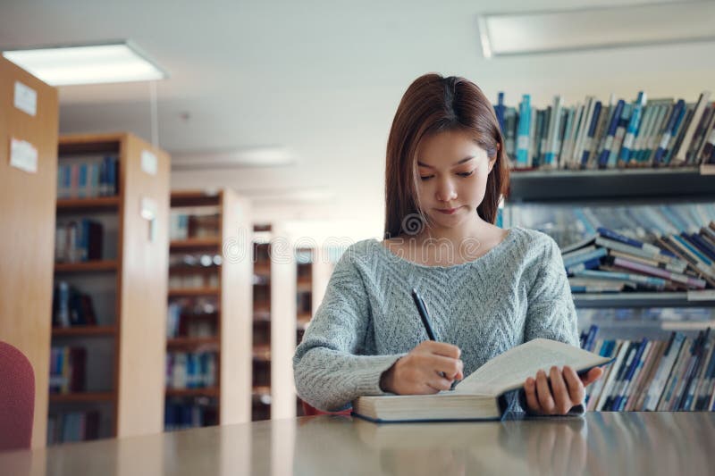 Asian Woman Student Writing Notes with Textbooks for Knowledge ...