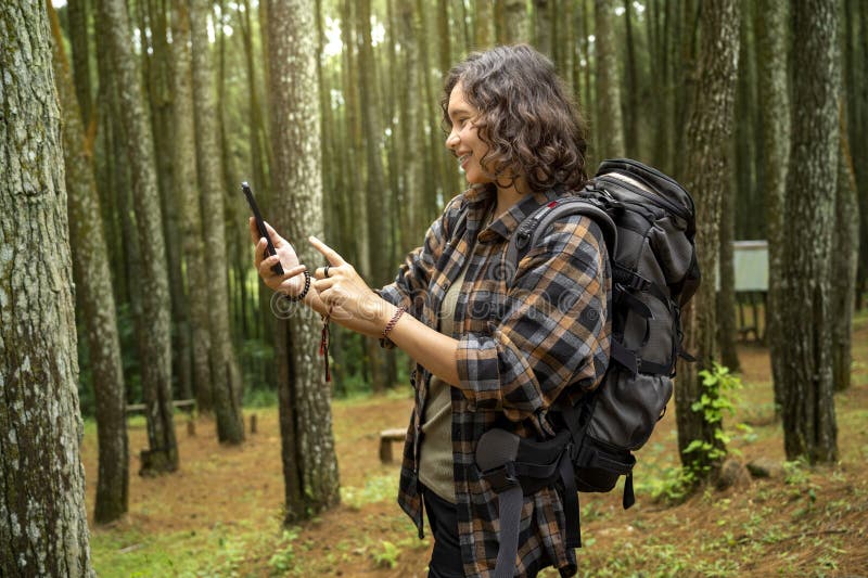 Asian Woman Trekking while Using Mobile Phone in the Forest Stock Photo ...