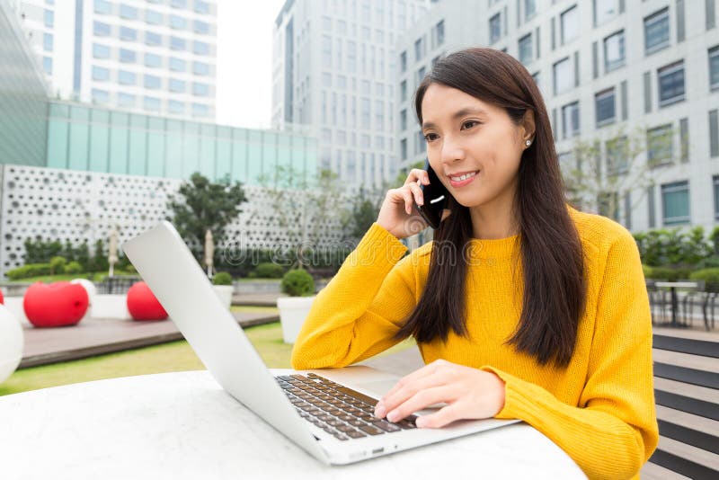 Asian Woman Use Computer and Talk To Cellphone Stock Image - Image of ...