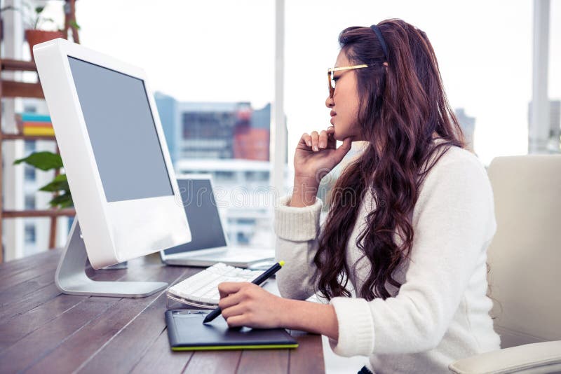 Asian Woman Using Digital Board and Looking at Computer Monitor Stock ...