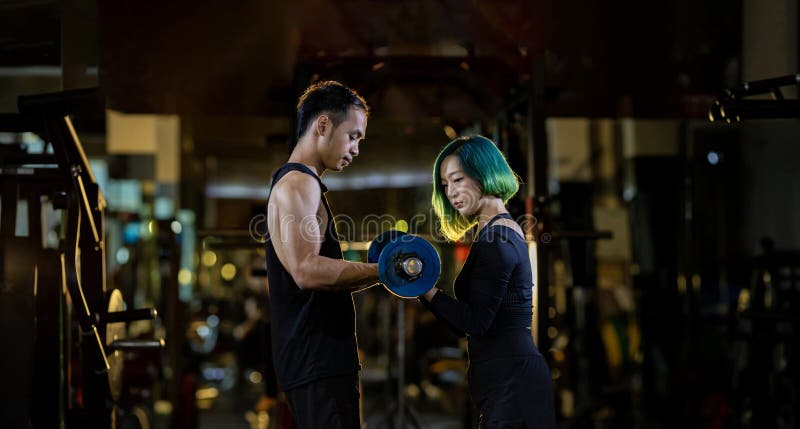 Asian Woman is Using Easy Bar As Beginner in Weight Training on Barbell ...
