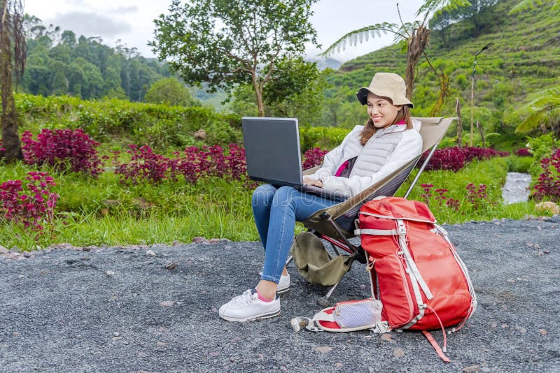 Asian Woman Using a Laptop while Enjoying Camp Activity Stock Image ...