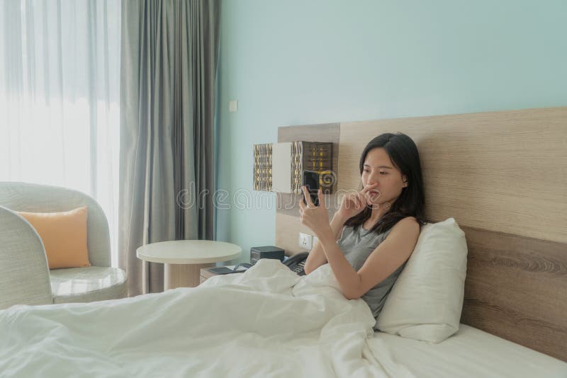 Asian Woman Using a Mobile Phone, Thinking about Problems and Suffering ...