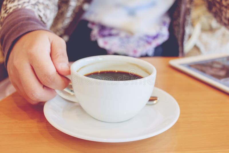 Asian Woman Using Tablet Computer In Cafe Drinking Coffee. Stock Photo ...