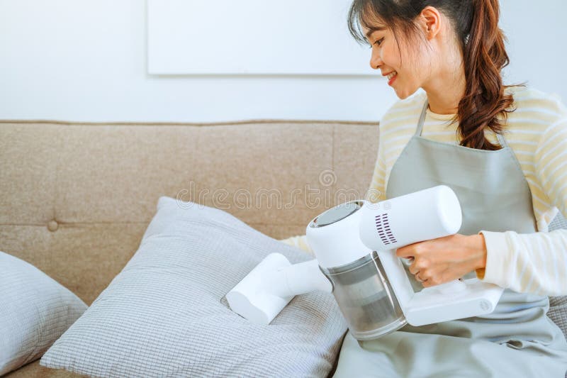 Asian Woman Using Vacuum Machine Cleaning Sofa. Housekeeping Concept ...