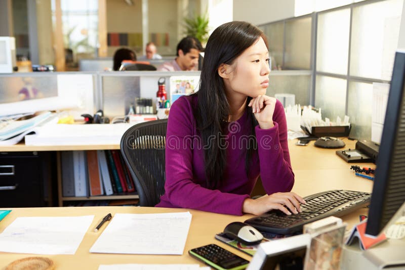 Asian Woman Working at Computer in Modern Office Stock Image - Image of ...