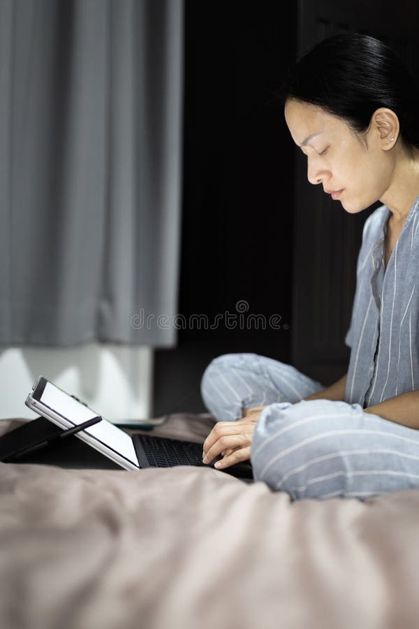 Asian Woman Working with Laptop Computer in Bed at Night. Stock Photo ...