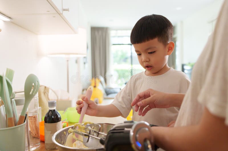 Asian Woman and a Young Boy are Engaged in a Baking Stock Image - Image ...