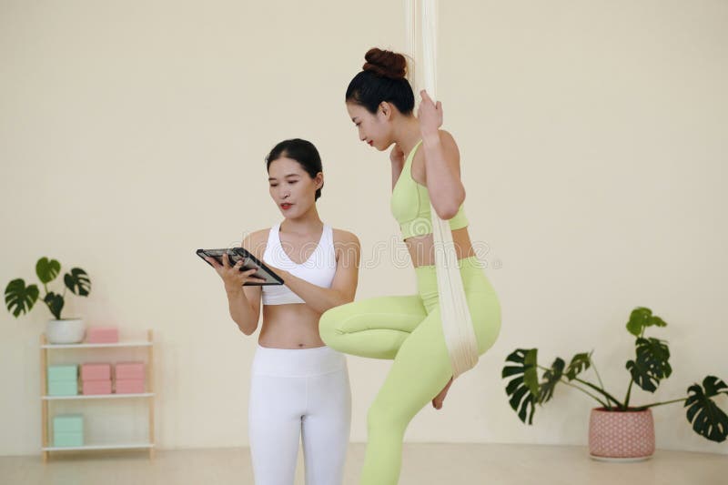 Asian Women Engaging in Aerial Yoga Stretching Stock Photo - Image of calm, asian: 330594476