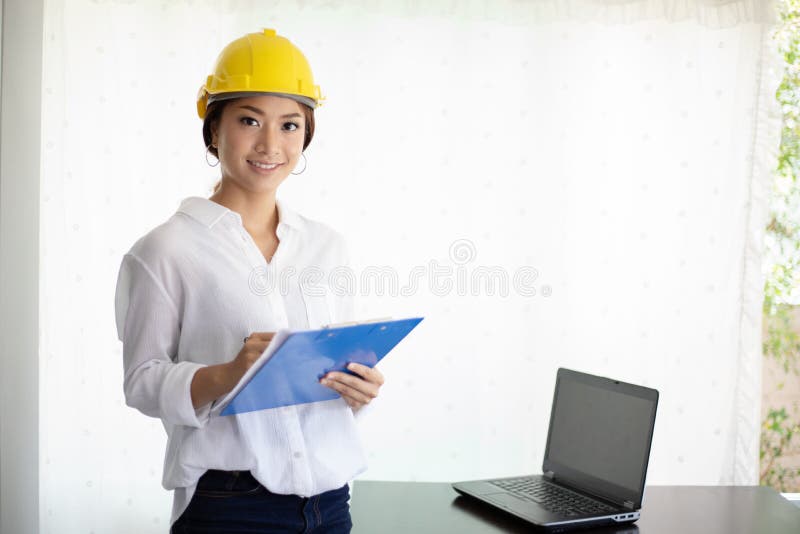 Asian Women Engineering Inspecting and Working and Holding Blueprints ...