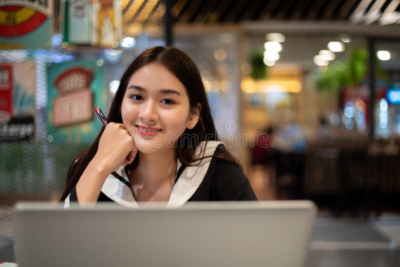 Asian Women Working and Learning Online with Computer Notebook. she ...