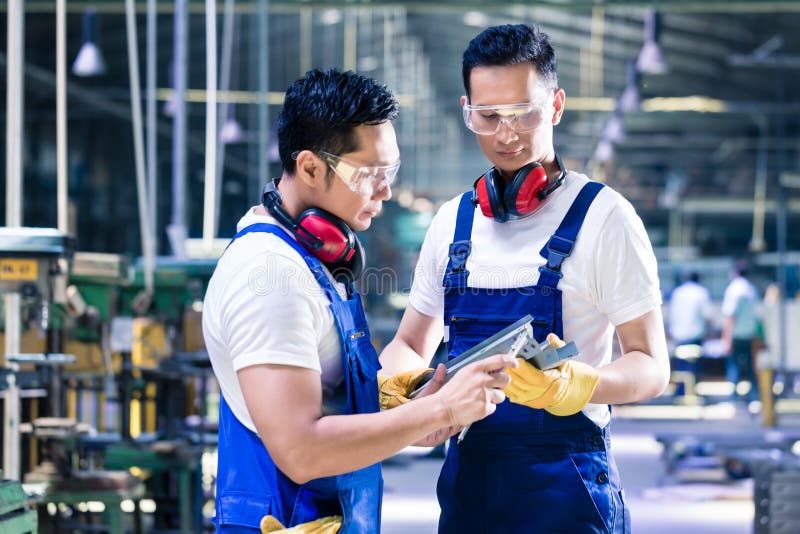 Asian Worker Using a Machine in a Factory Stock Photo - Image of asians ...