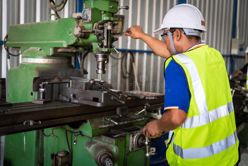 Asian Worker Operating Lathe Grinding Machine - Metalworking Industry ...