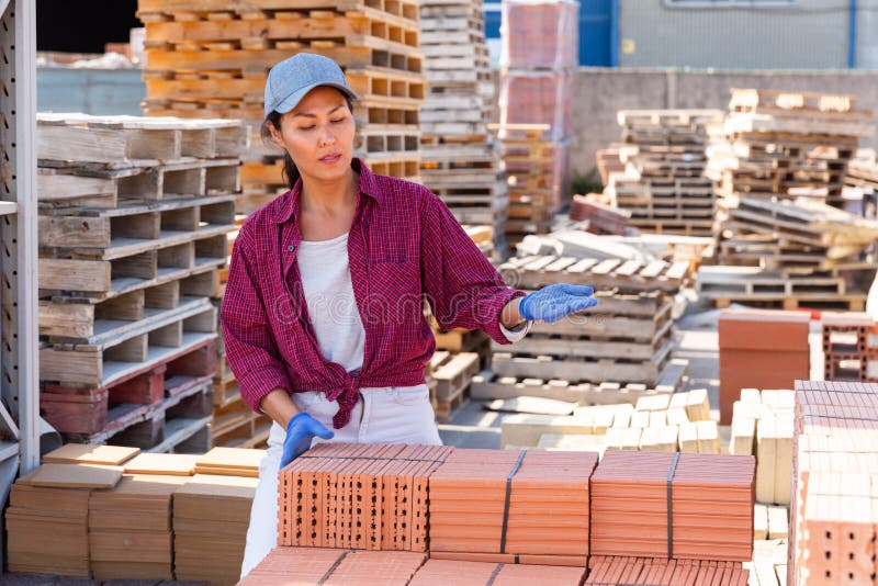 Asian Worker Stacking Bricks in Warehouse of Building Materials on an ...