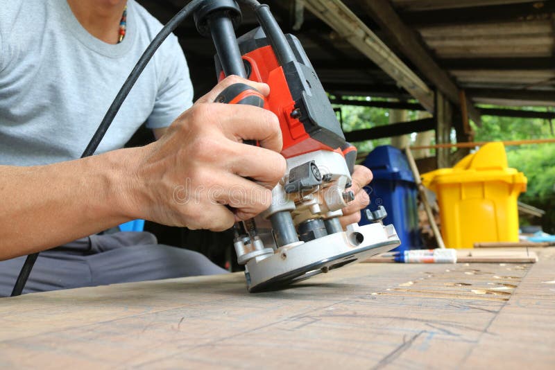 Asian Workers Using Electric Routering To Cut the Wood. Stock Photo ...
