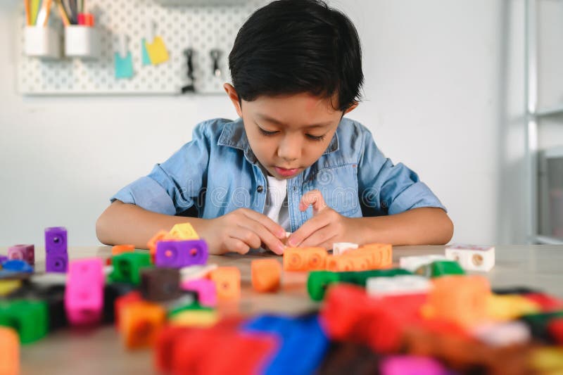 Asian Young Child Playing Colorful Plastic Cubes on Desk at Home ...