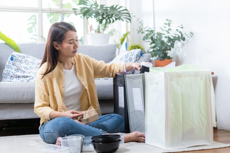Asian Young Female Sitting at Home Separating Paper and Plastic Waste ...