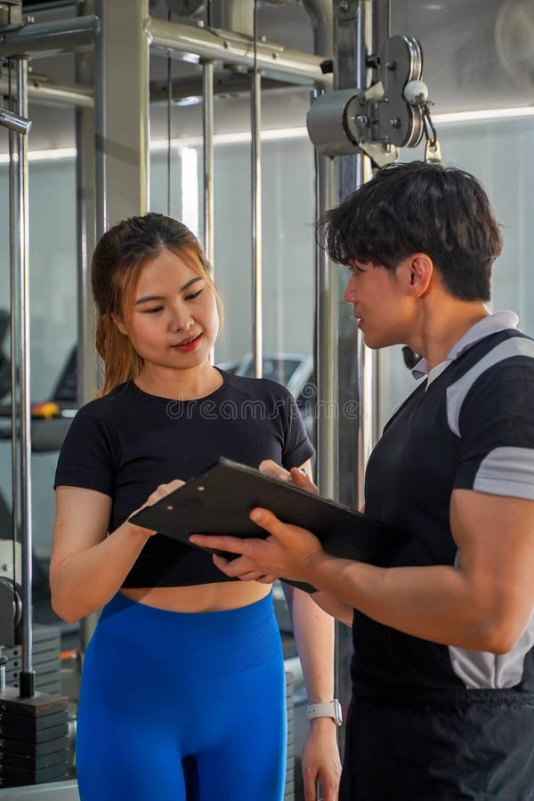 Asian Young Female Talking and Ask Fitness Trainer about the Interest ...