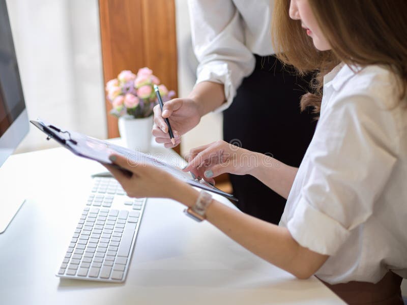 Female Trainee and Her Manager Working Together in the Office Stock ...