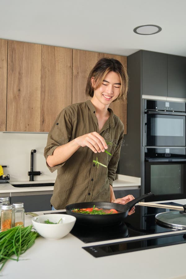 Asian Young Man Adding Chive To Prepare Taiwanese Tomato Scrambled Eggs ...