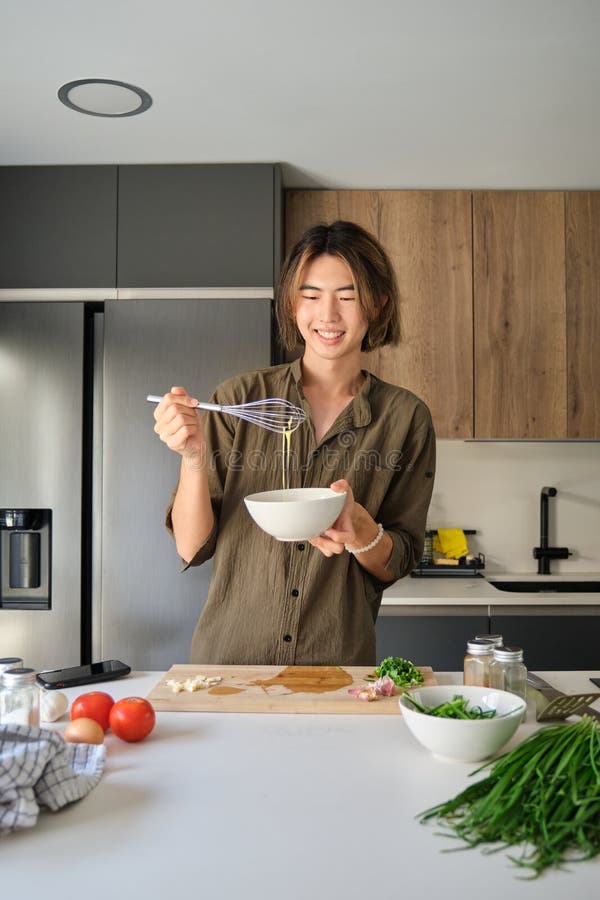 Asian Young Man Beating Eggs at Kitchen. Stock Image - Image of ...