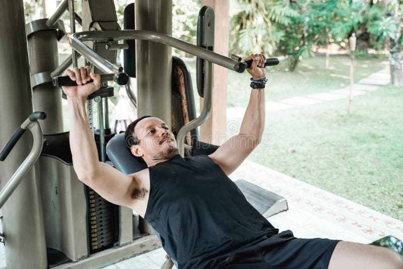 Asian Young Man Doing Chest Press Exercise Stock Image - Image of ...