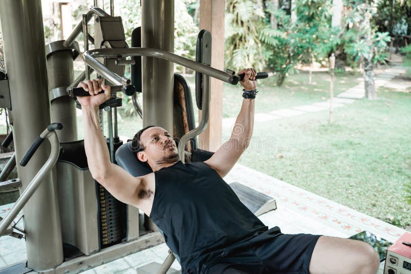 Asian Young Man Doing Chest Press Exercise Stock Photo - Image of ...