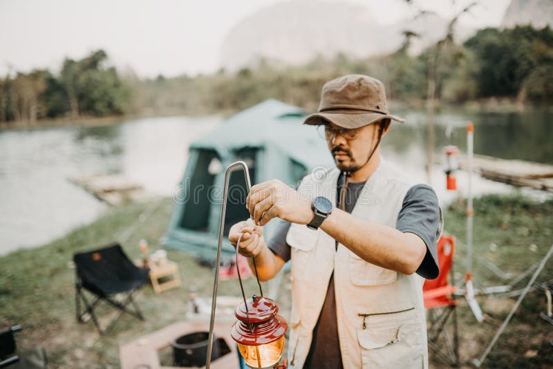 Asian Young Man Setting Up Lanterns in Camping Stock Photo - Image of ...