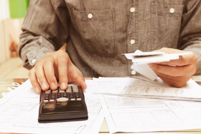 Asian Young Man Sitting on Home Office Using Calculator and Calculating ...