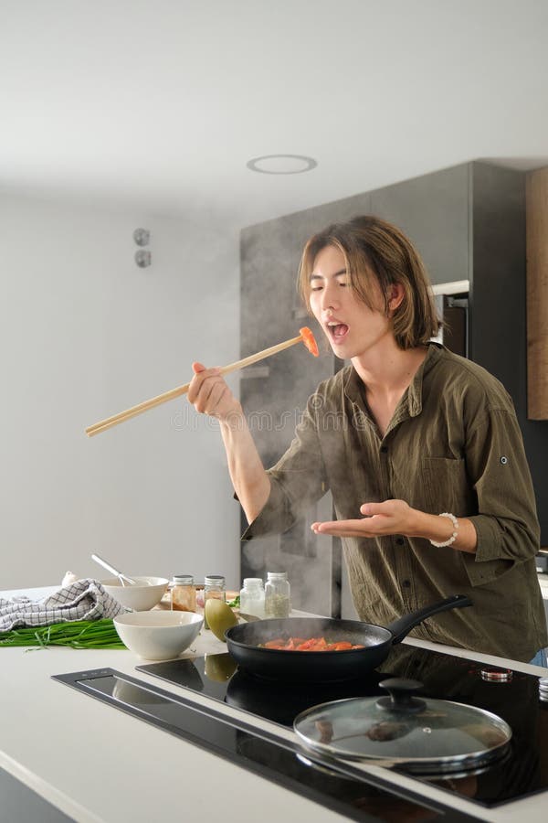 Asian Young Man Testing Taiwanese Tomato Scrambled Eggs he is Cooking ...