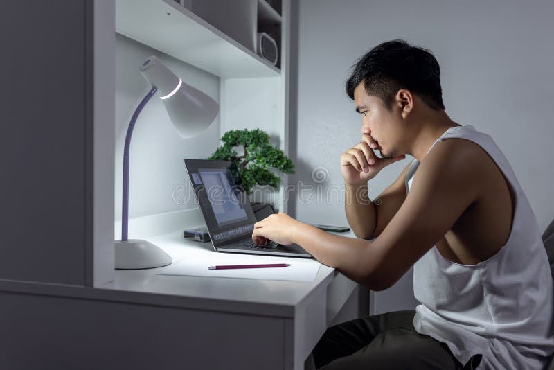Asian Young Man Working on His Computer Inside the Room at Night Stock ...