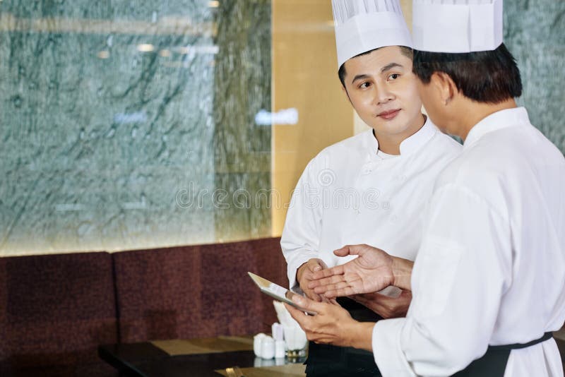 Chef Talking to New Worker stock image. Image of diverse - 287237661