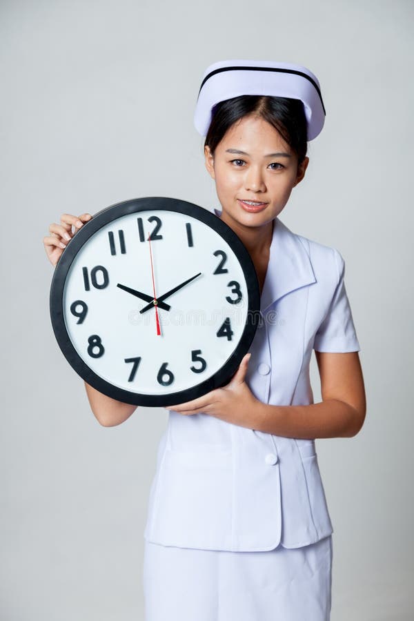 Asian Young Nurse with a Clock Stock Photo - Image of appointment ...