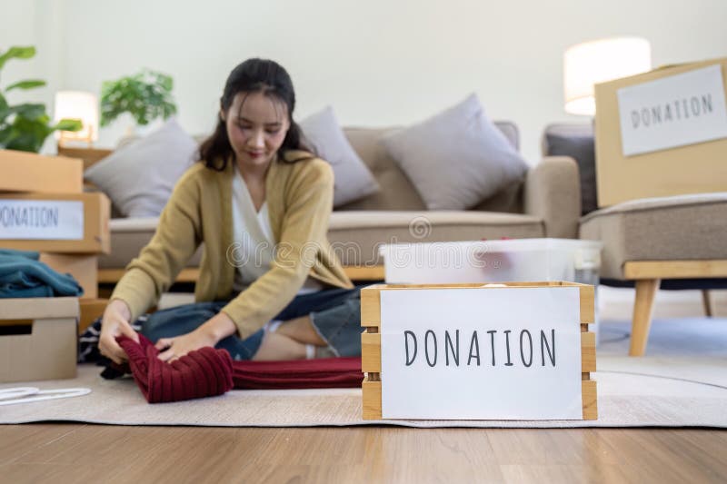 Asian Young Woman Packing Clothes at Home, Putting on Stuff into Donate ...