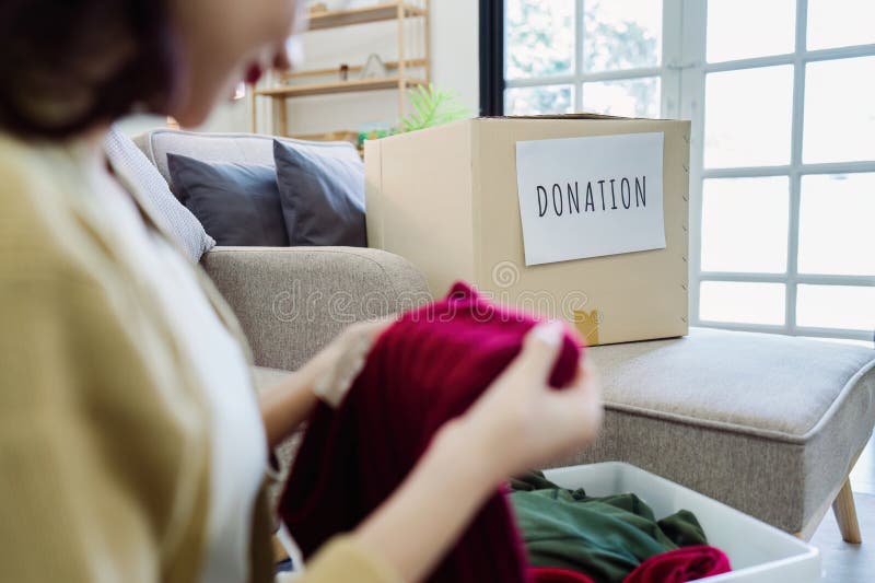 Asian Young Woman Packing Clothes at Home, Putting on Stuff into Donate ...