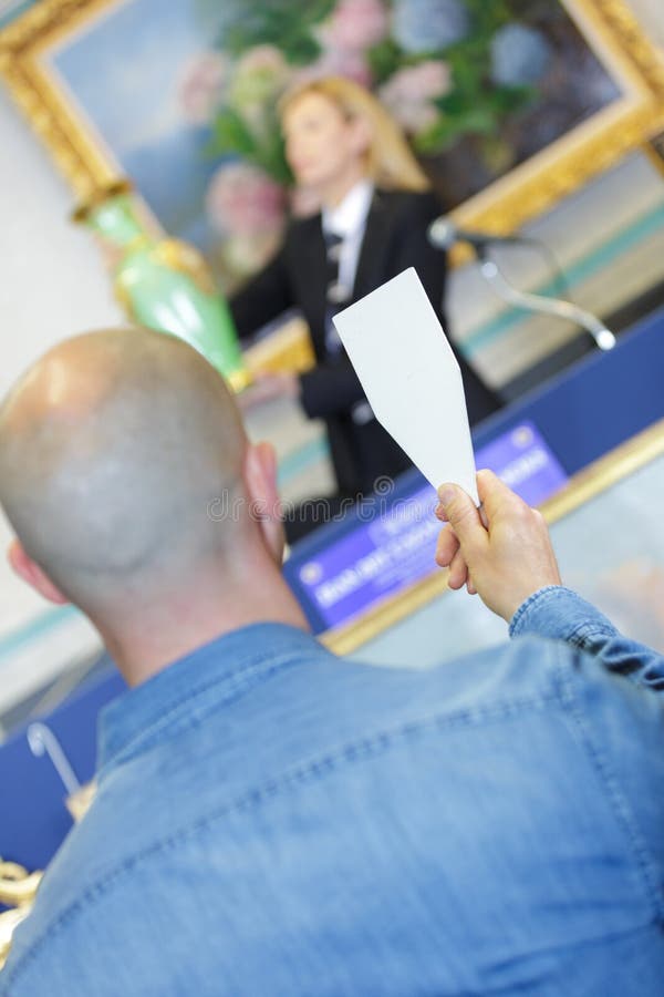 Asking for the bid stock image. Image of consignor, vase - 150199853