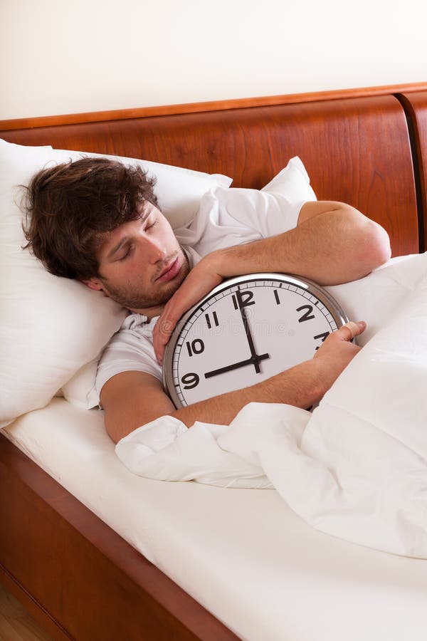 Asleep man with clock stock photo. Image of disturbed - 42261930