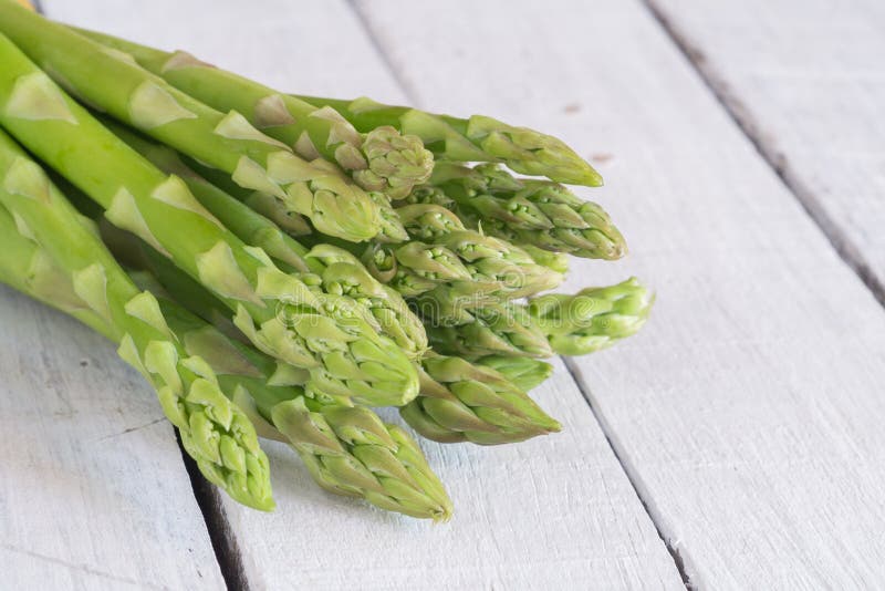 Asparagus on wooden table stock image. Image of cooking - 53344059